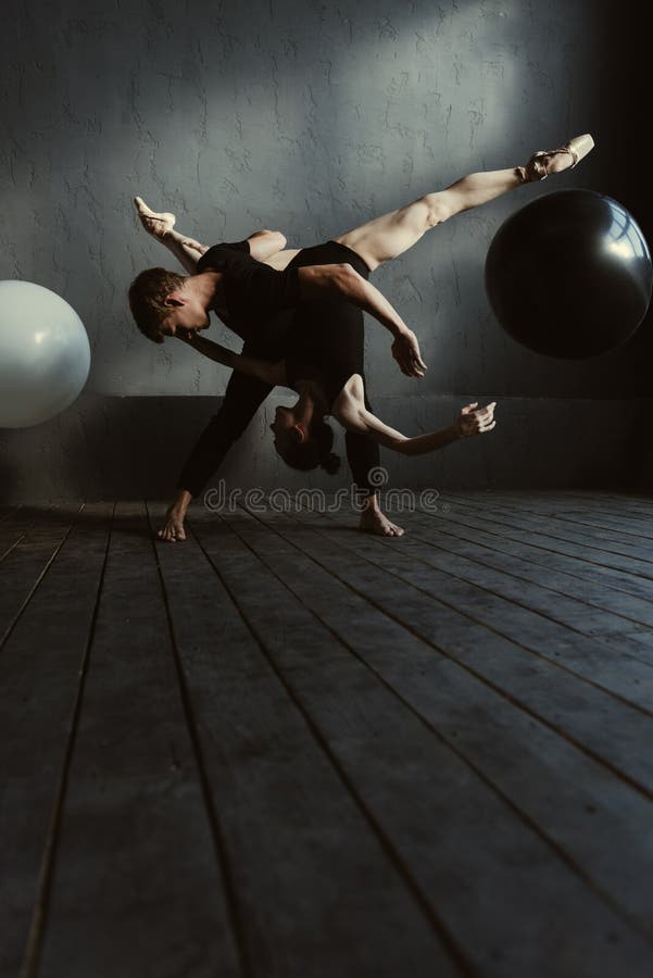 Flexible Ballet Dancer Stretching in the Dark Lighted Studio Stock ...