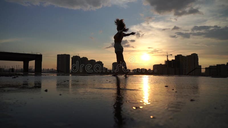 Flexible Female Gymnast Doing Acrobatic Tricks with Reflection in the ...