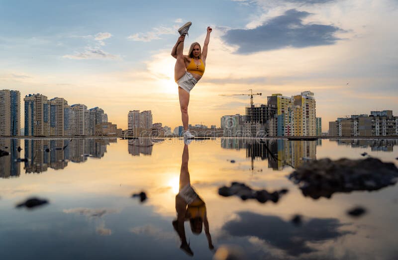 Flexible Female Gymnast Making Trick with Reflection in the Water ...