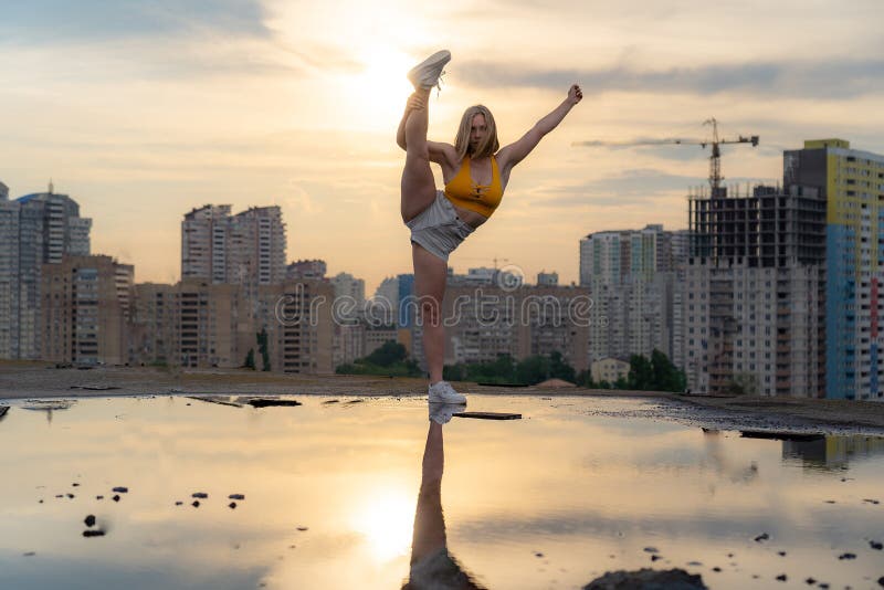 Flexible Female Gymnast Standing Split with Reflection in the Water ...
