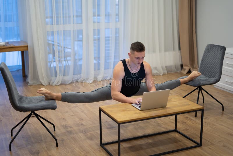 Flexible Man Work on Laptop and Doing Leg-split at Home. Concept of ...
