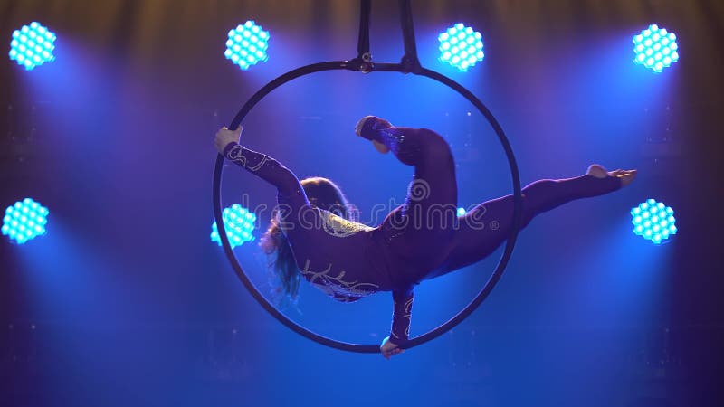 Flexible Woman Hanging in an Aerial Acrobatics Ring Performs Complex ...