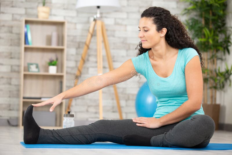 Flexible Woman Reaching Toes during Stretching Exercise Stock Photo ...