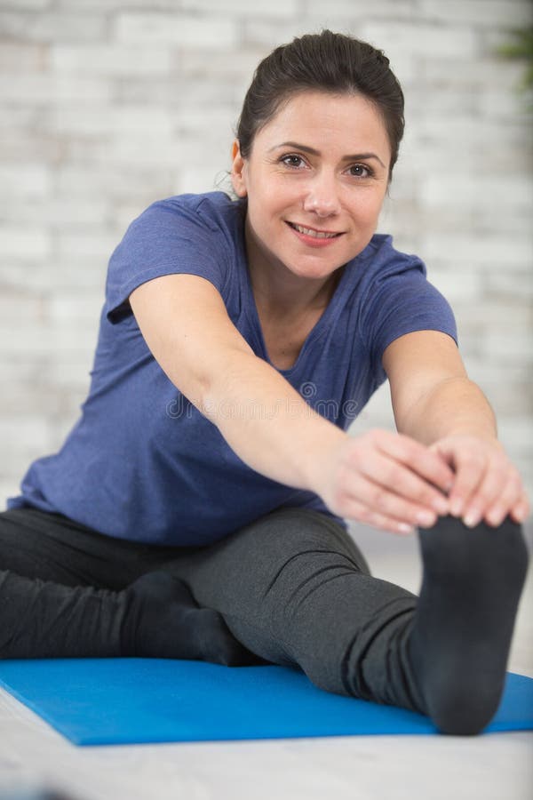Flexible Woman Reaching Toes during Stretching Exercise Stock Photo ...