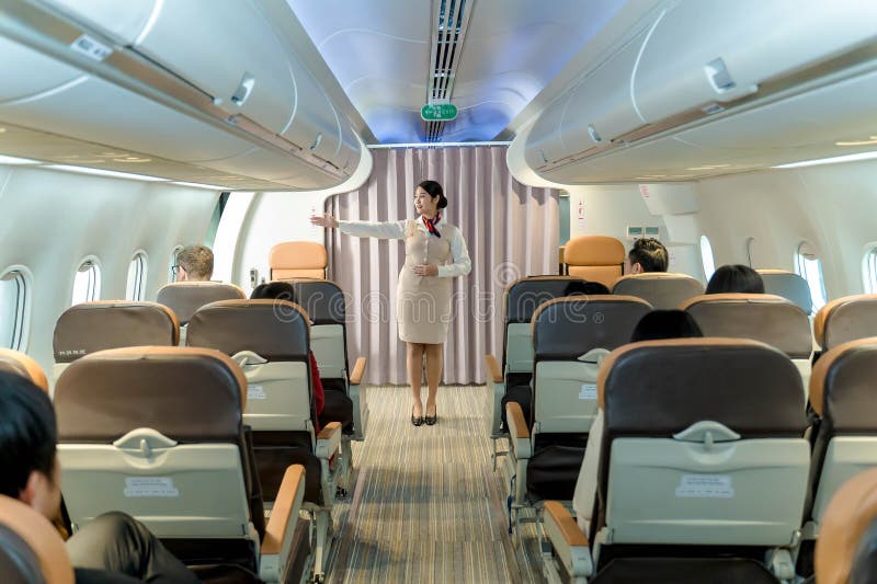 Flight Attendant Pointing To the Emergency Exit during Pre-flight ...