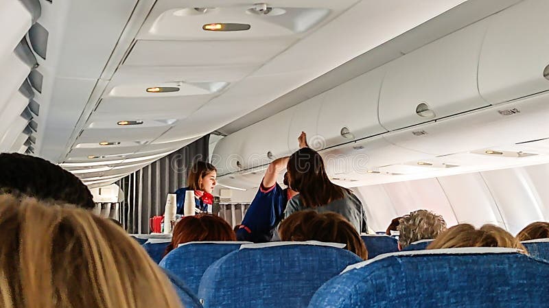 Flight Attendants Serve Passengers on the Airplane Editorial Image ...