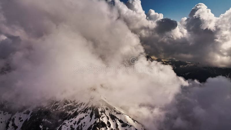 Flight in the Clouds of Vertical Development Over the Mountains during the Day. Aerial View ...