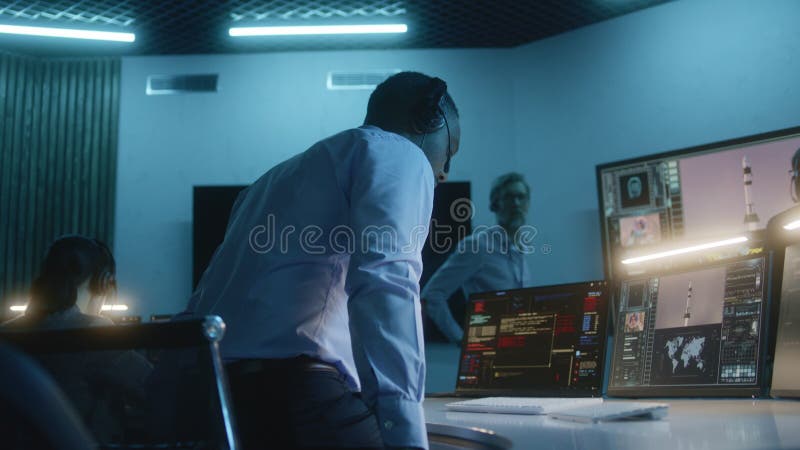 Flight Control Employee Puts on Headset, Monitors Space Mission on ...
