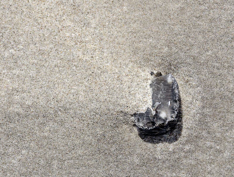 Flint stone on sand stock image. Image of smashed, sand - 150875665