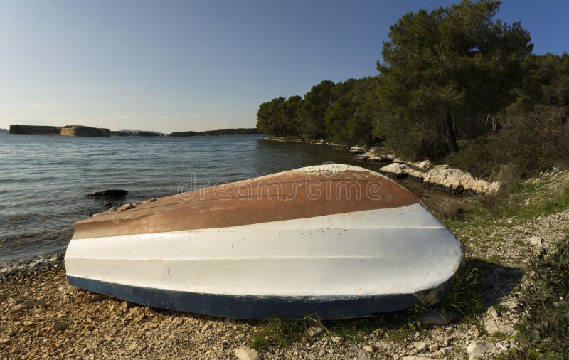 Flipped boat on a coast stock image. Image of coast, beautiful - 69391395