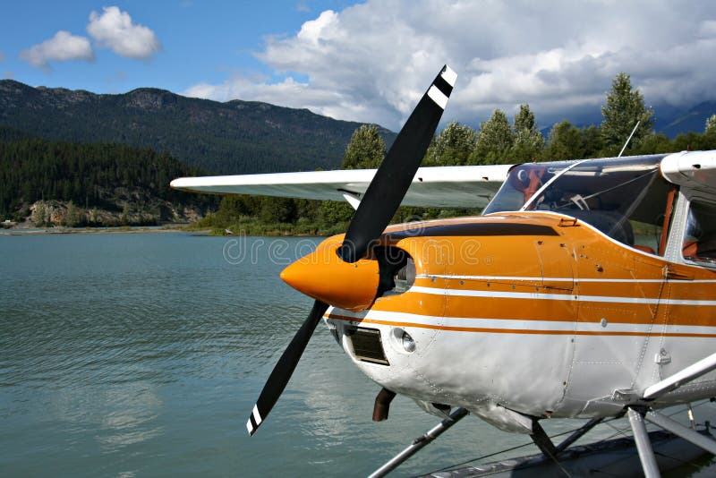 Alaska Float Plane Moored at Dock Amid Foliage Reflections Stock Image ...