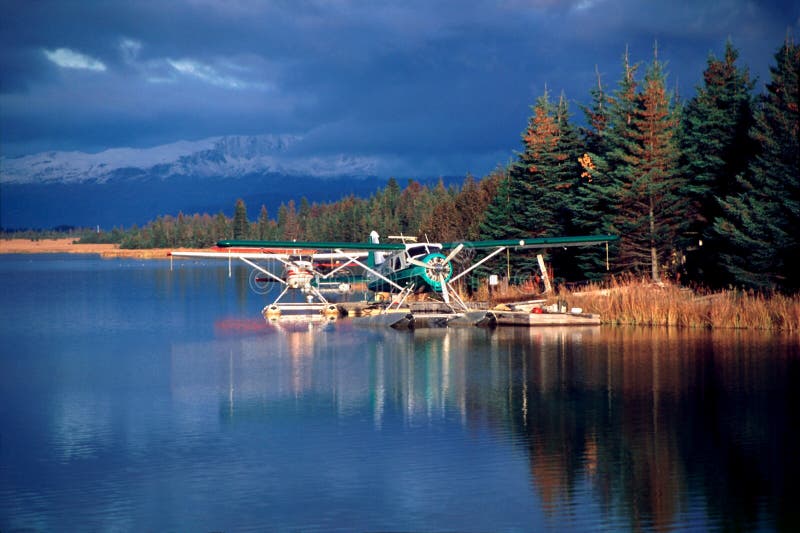 Alaska Float Plane Moored at Dock Amid Foliage Reflections Stock Image ...