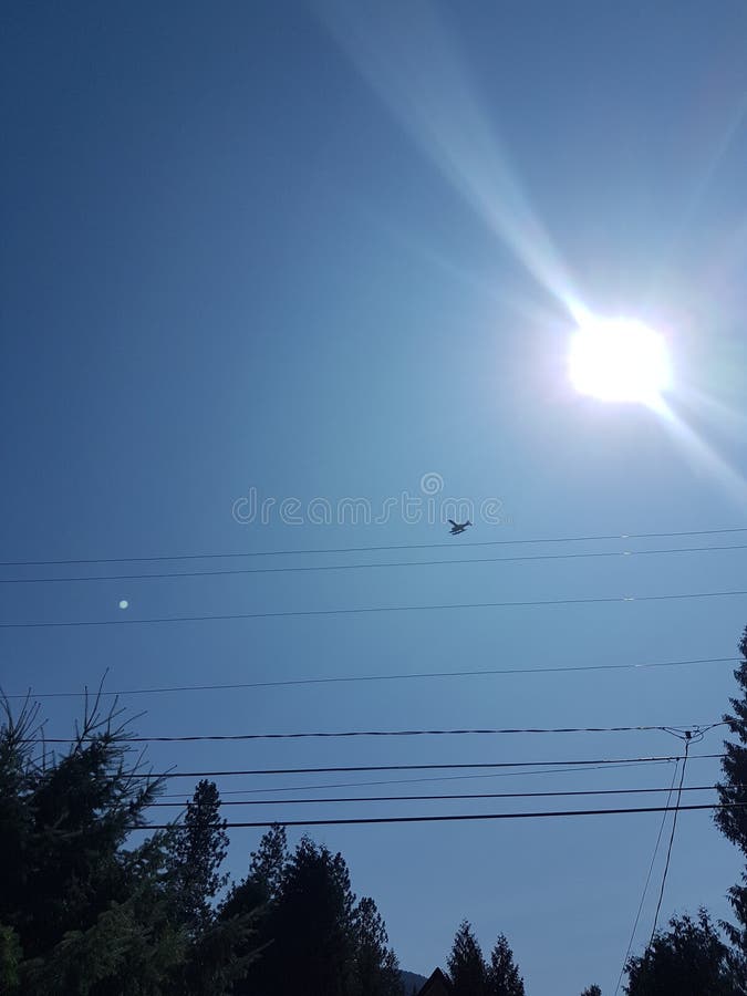Float Plane Flying in Blue Sky Stock Photo - Image of float, flying ...