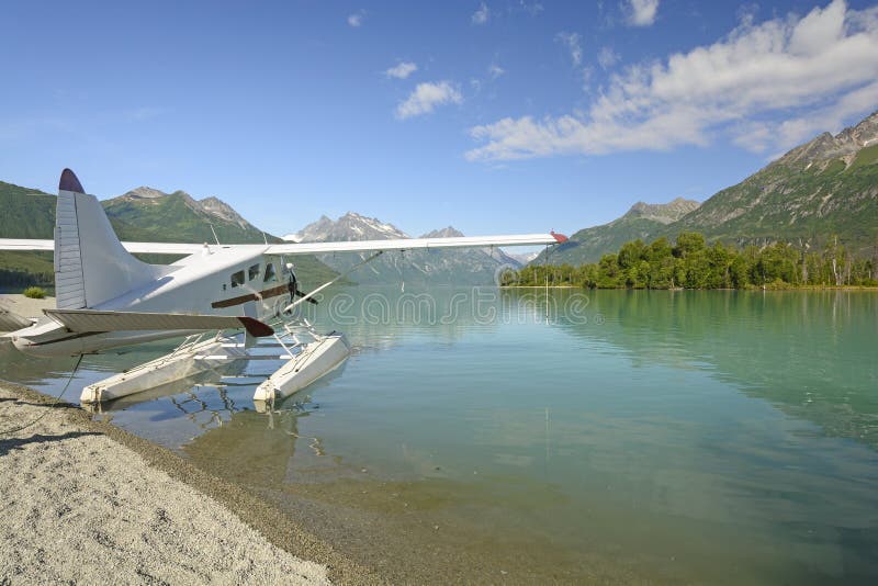 Alaska Float Plane Moored at Dock Amid Foliage Reflections Stock Image ...