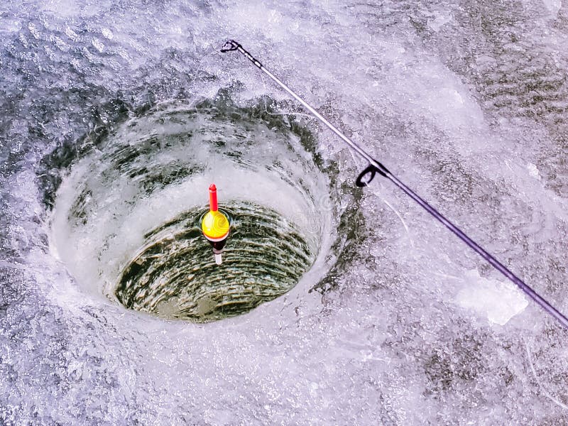 A Float Sits in a an Ice Fishing Hole. Stock Image - Image of arctic ...