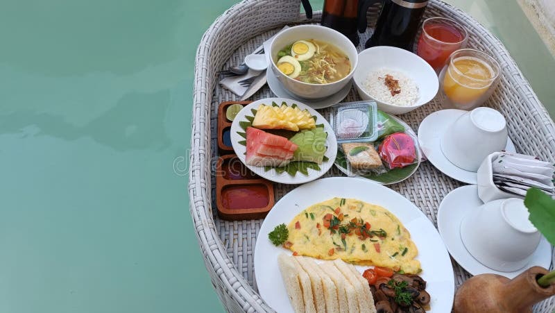 Floating Breakfast Tray with Tropical Fruits by Poolside Stock Image ...
