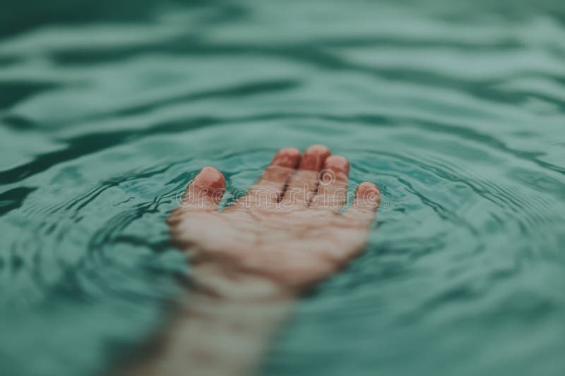 Floating Hand Above Tranquil Water Evokes Peace in a Harmonious ...