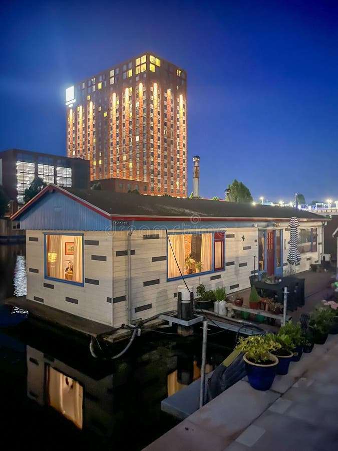 A Floating House on the Canals of Amsterdam in the Netherlands Stock ...