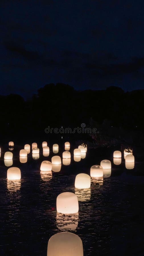 Floating Lanterns on a Serene River at Night. Stock Image - Image of ...