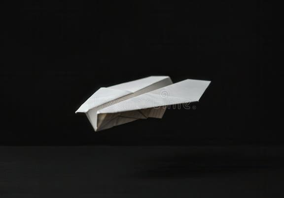 A Floating Paper Airplane in Flight Position, on a Solid Black ...