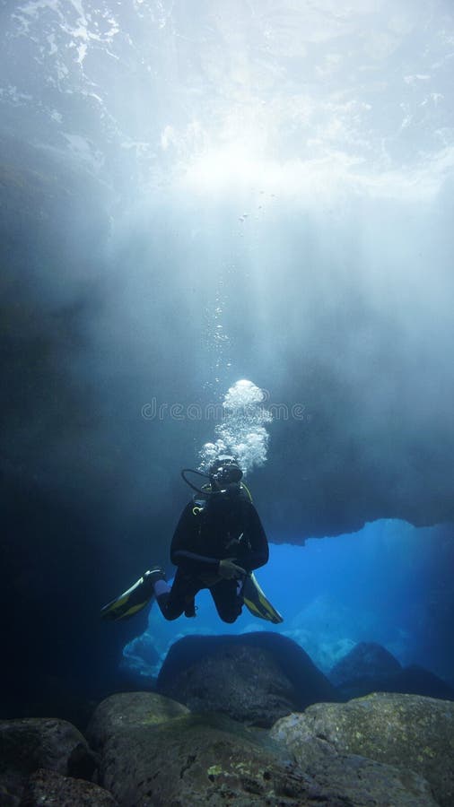 Floating in Rays of Light Inside a Cave Stock Image - Image of explore ...