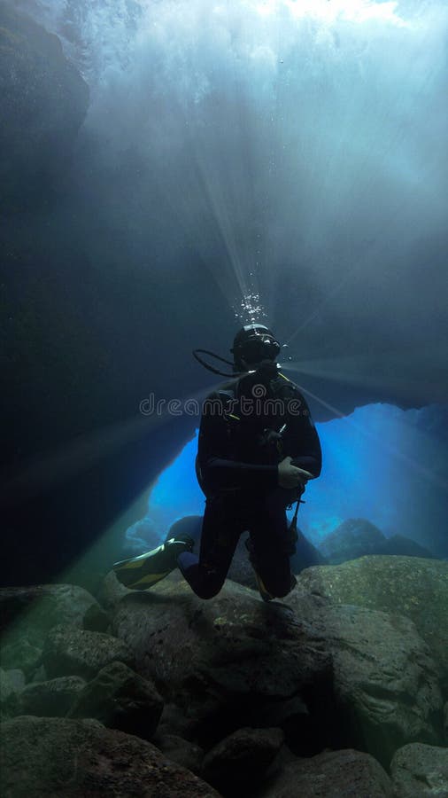 Floating in Rays of Light Inside a Cave Stock Image - Image of explore ...