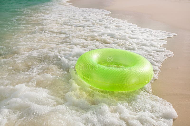 Floating Ring on Sandy Beach with Waves Stock Photo - Image of beach ...