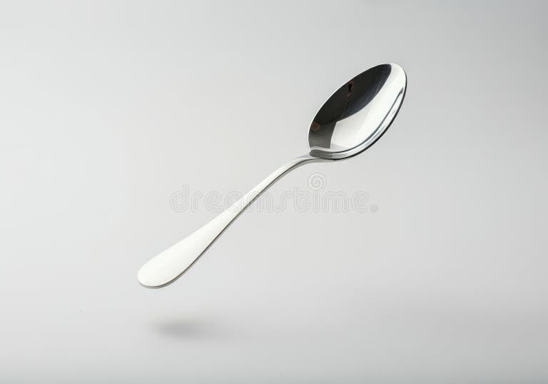 A Floating Silver Spoon with a Polished Finish, on a Solid White ...