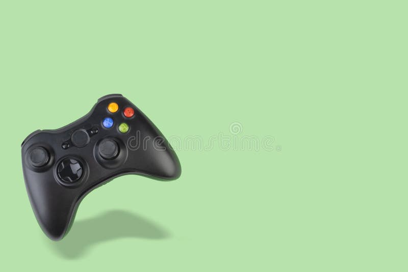 Floating Video Game Controller Over Green Background with Copy Space ...