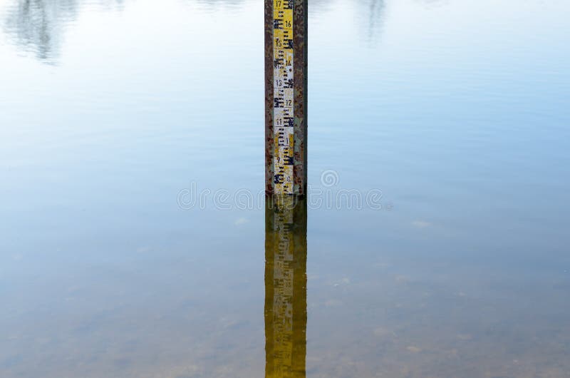 Flood level scale pillar stock image. Image of mirrored - 86242795