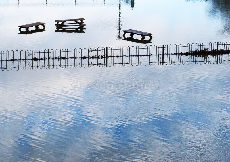 Three flooded park benches stock photo. Image of water - 30205536