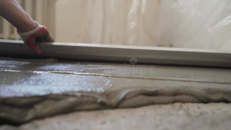 Screed Construction Work, a Man Levels a Concrete Screed Indoors ...