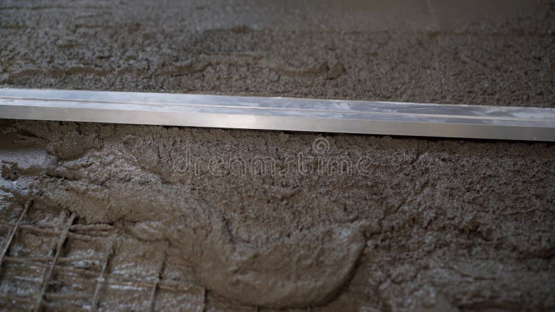 Floor Cement Work. Plasterer Smoothing Floor Surface with Screeder ...