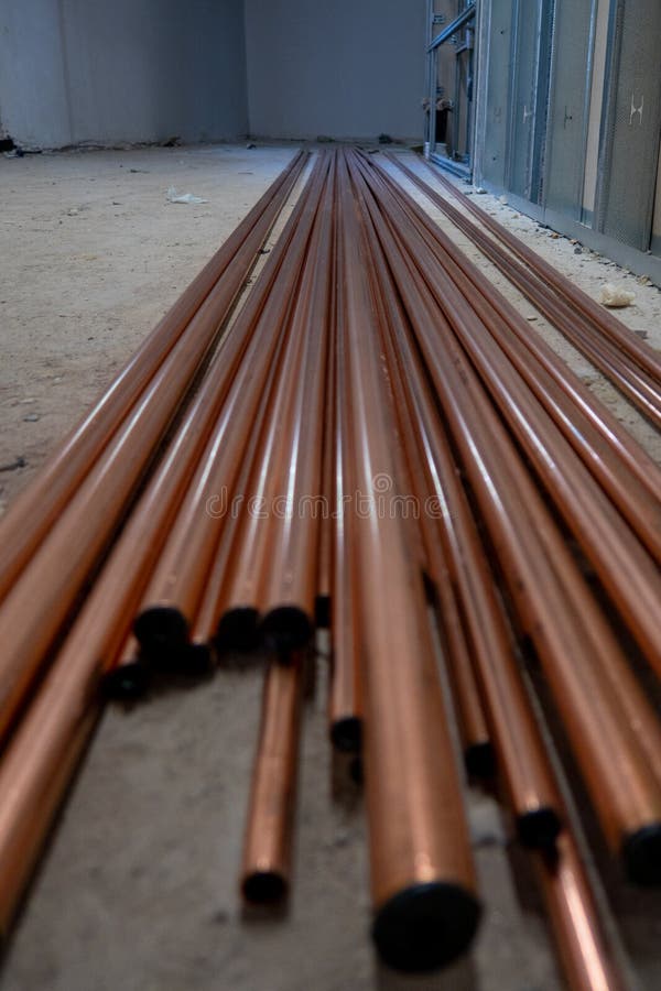 On a Floor of a Construction Site are Many Copper Pipes Stock Image ...