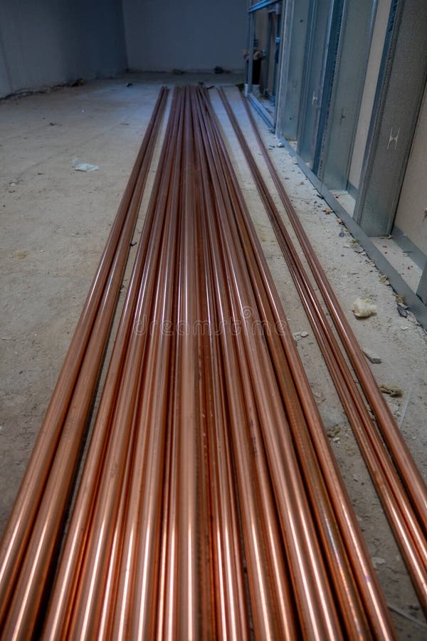 On a Floor of a Construction Site are Many Copper Pipes Stock Image ...