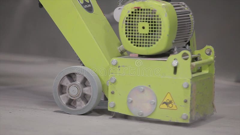 Floor Grinding at a Construction Site. a Builder Works with an ...