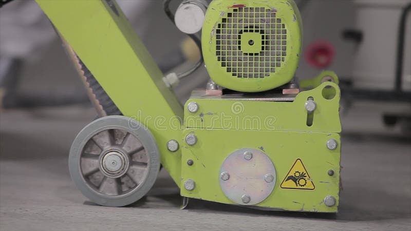 Floor Grinding at a Construction Site. a Builder Works with an ...