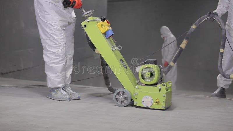 Floor Grinding at a Construction Site. a Builder Works with an ...