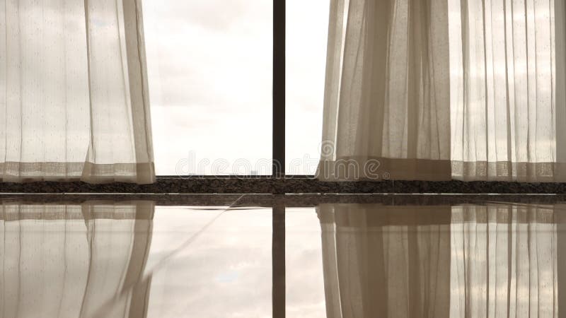 On the Floor is Reflect of Curtains Waving in Wind from an Open Window ...