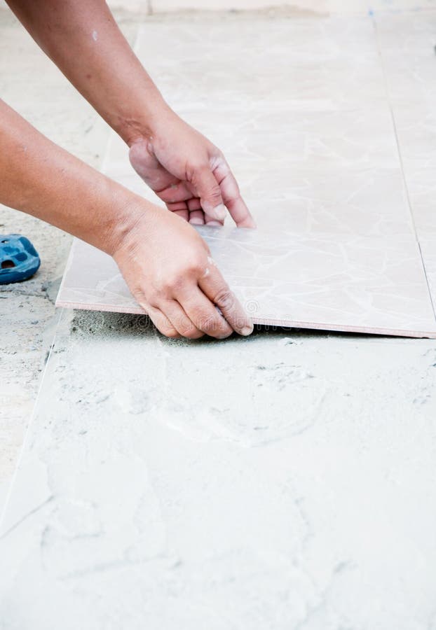 Man installing floor tile stock image. Image of skilled - 16263681