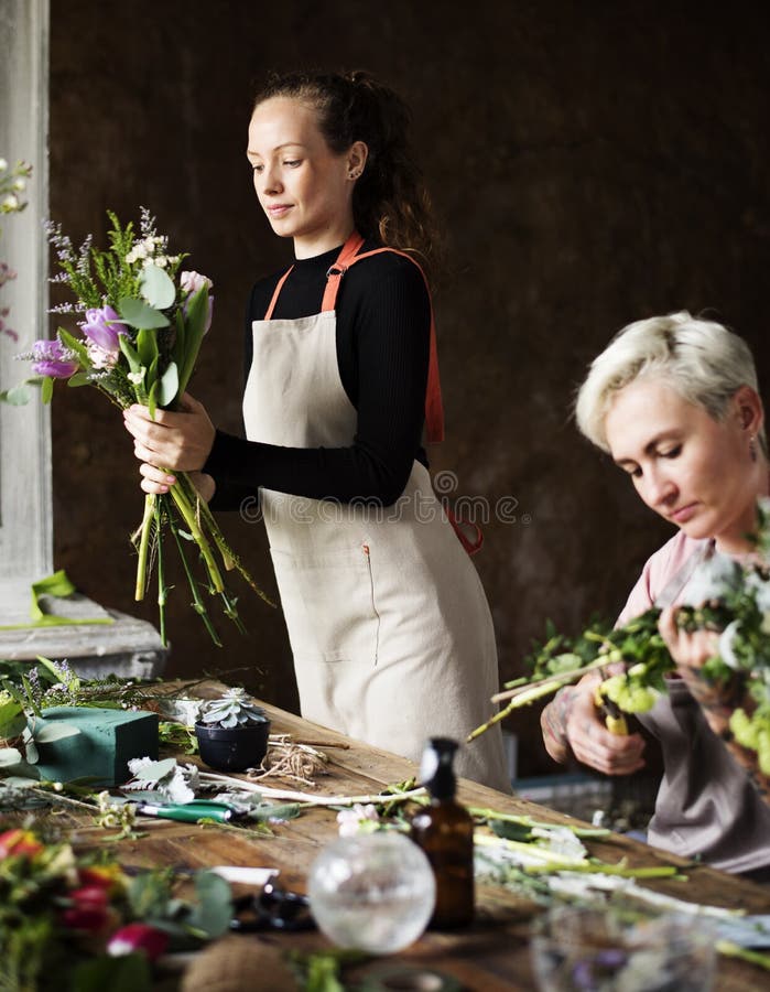 Florist Making a Bouquet of Beautiful Branches with Red Berries and ...