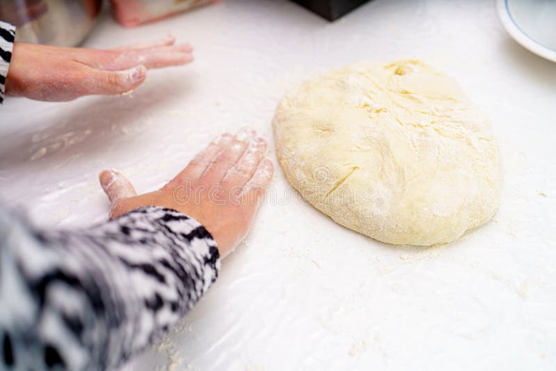 Hands Kneading Dough on a Clean Surface in a Cozy Kitchen during a ...