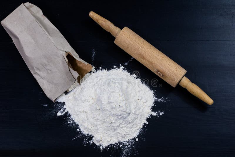 Flour and Rolling Pin for Kneading the Dough on the Kitchen Table ...