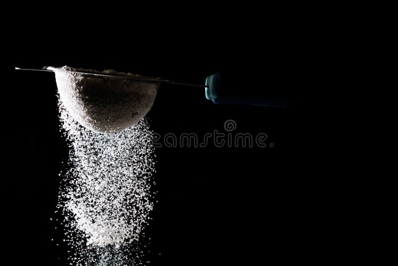 Flour Sifting on a Black Background. White Powder Sift Isolated on ...