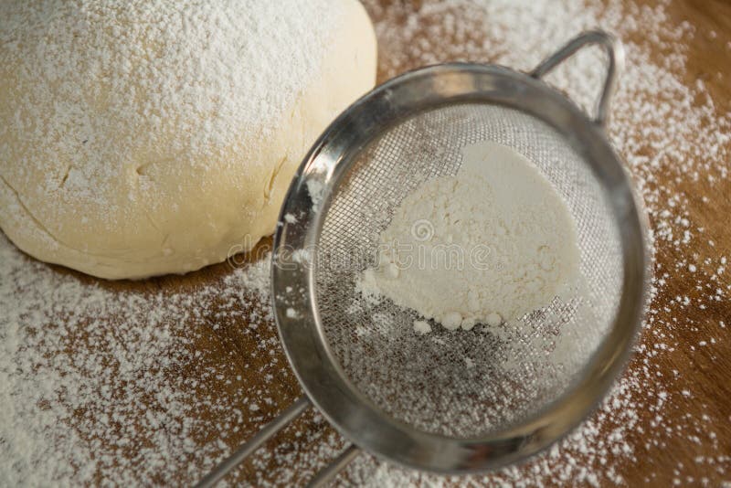 Flour sprinkled over dough stock photo. Image of season - 101343044