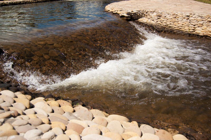The Flow of Water in an Artificial Stream with a Bed of Pebbles Stock ...