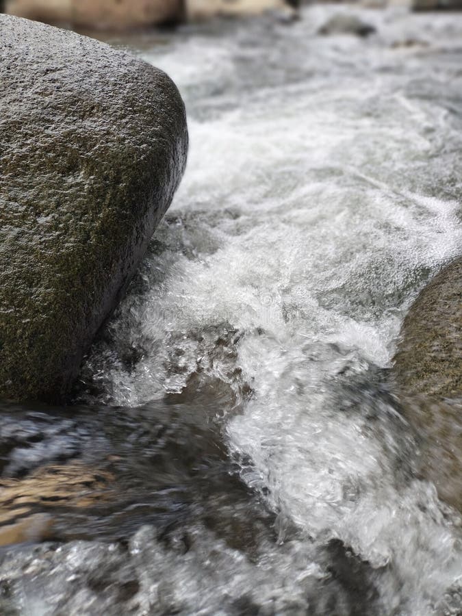 The Flow of Water in the River Passing through a Gap in the Rocks ...