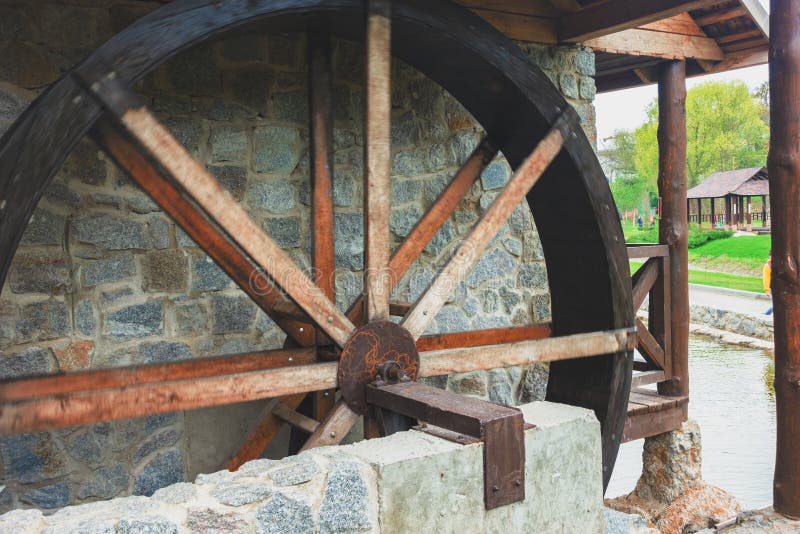 The Flow of Water Rotates the Wooden Wheel at the Old Mill Stock Image ...