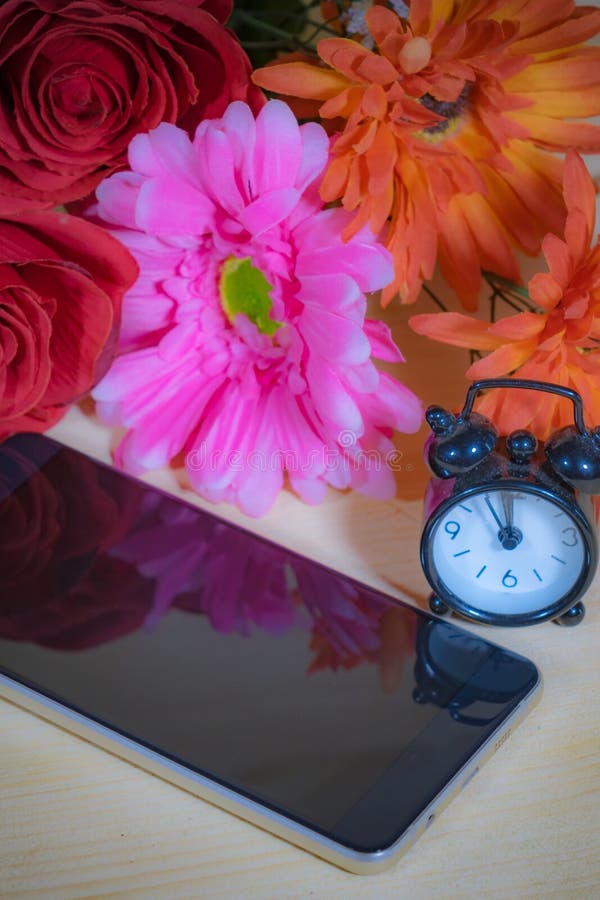 Flower with Alarm Clock and Phone Stock Photo - Image of bunch, growth ...