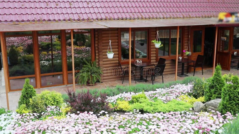 Flower Bed and Wooden House with Cafe at Spring Stock Footage - Video ...